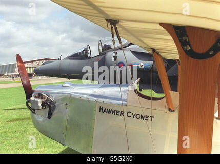 Pictured side by side, the Hawker Cygnet biplane of 1924 (middle) and a ...