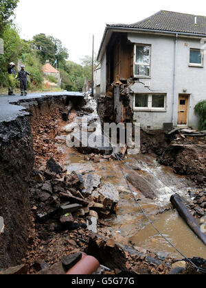 Workmen view the damage caused in Dura Den in Fife after heavy rainfall ...