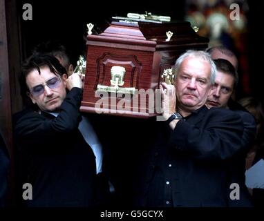 Lead singer of U2 Bono helps carry his father Bob Hewson's coffin, at ...