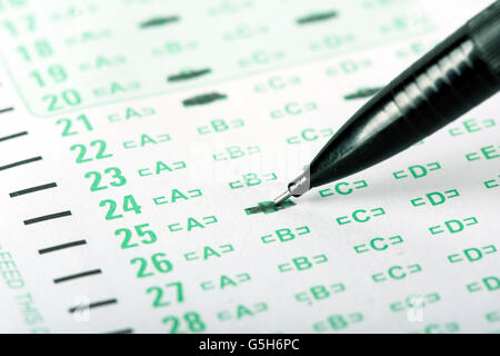 Optical scan answer sheet for a school exam with student erasing answer ...