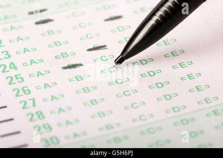 Optical scan answer sheet for a school exam with student erasing answer ...