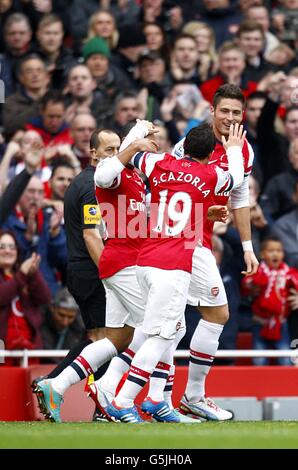 Arsenal's Olivier Giroud, left, and Arsenal's Theo Walcott hold up the ...