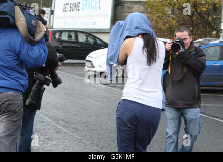 Jennifer Toland, 23, hides her face as she leaves Ballymena Magistrates ...