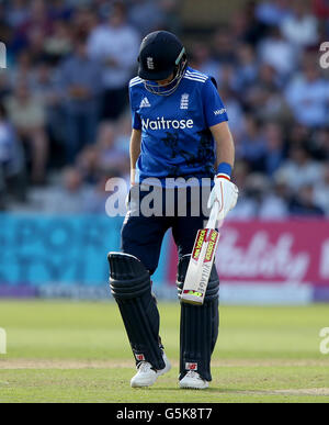 England’s Joe Root walks off the ground and raises his bat after being ...