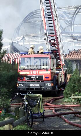Firemen tend to the fire that has destroyed the Plaza Complex at the ...