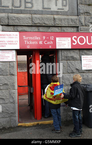 Fans go through the turnstiles at Pittodrie Stadium home of Aberdeen ...