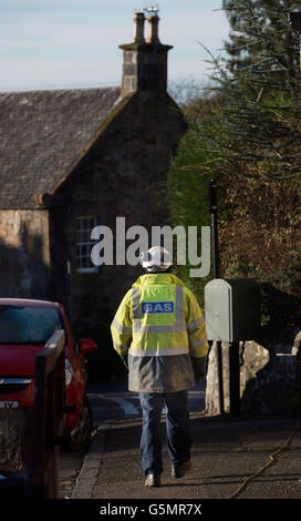A Scotland Gas Networks employee works to restore gas to a house in ...
