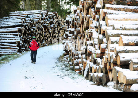 A man walks past a snow covered wall after a heavy snowfall in Prague ...