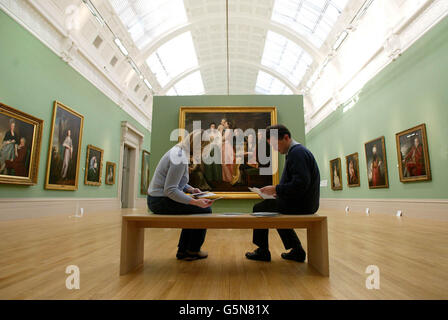 Alex Kidson, curator of the Romney exhibition, with portraits of Lady ...
