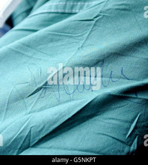 Nurse Karla Graham shows off the autograph of the Prince of Wales, who ...