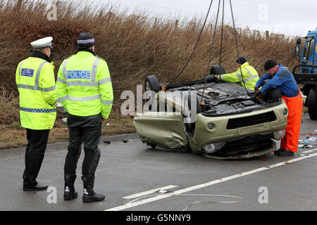 Crash investigators view a gold Nissan Note as it is removed from the ...
