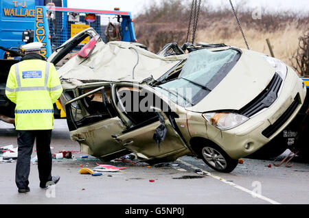 Crash investigators view a gold Nissan Note as it is removed from the ...