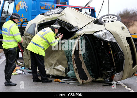 Crash investigators view a gold Nissan Note as it is removed from the ...