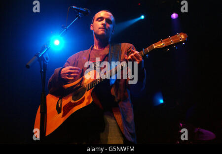 Fran Healy (L) lead singer of Travis talks to bass guitarist Dougie ...