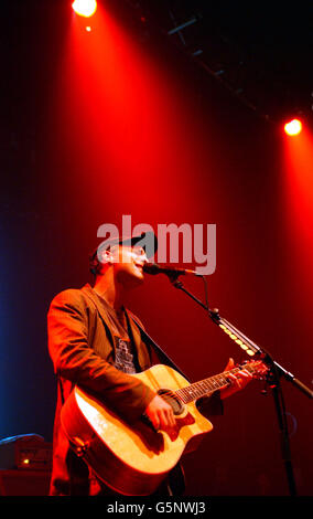 Fran Healy (L) lead singer of Travis talks to bass guitarist Dougie ...