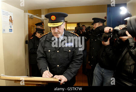 Garda Commissioner Martin Callinan signs a book of condolence inside ...