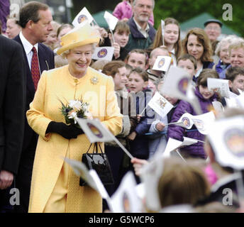 Queen Elizabeth II is greeted by school children from Hackness Church ...