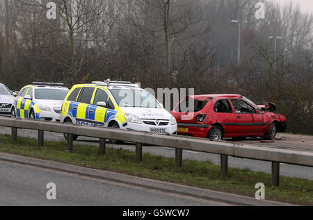 The wreckage of a red Ford Fiesta remains at the scene of a fatal car ...