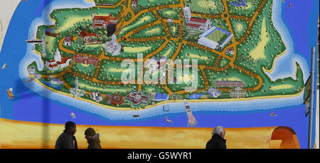 People walk past a mural depicting traditional Chinese architecture ...