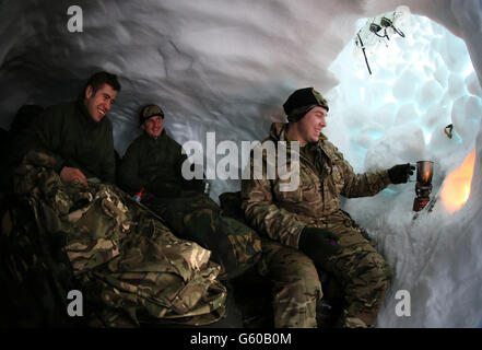 Marine Alistair McGoldrick from Chorley boils water from snow in his ...