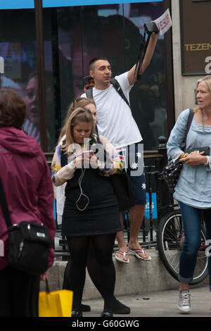 Religious preacher with Jesus poster preaching in Oxford Street London ...