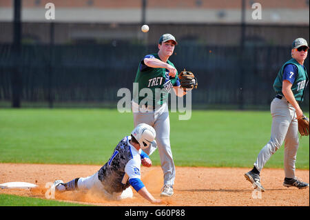 High school shortstop throwing to first base to retire an opposing ...