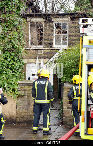Firefighters outside the remains of a house in Romford Road, Forest ...
