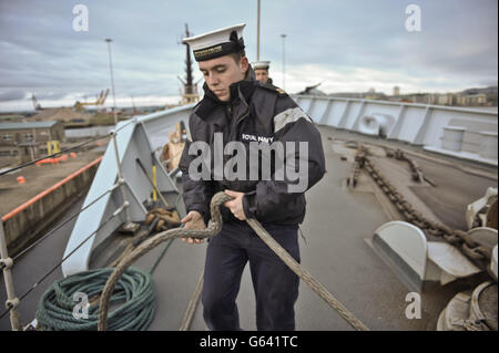 The crew of HMS Edinburgh ready ropes for berthing in Leith docks ...