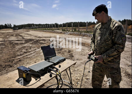 A soldier uses a games consol style controller to control a Terrier ...