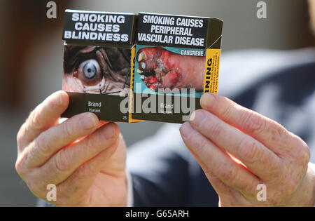 Irish Health Minister James Reilly holds examples of plain pack ...
