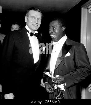 Louis “Satchmo” Armstrong, that great trumpeter of jazz, wipes his lips ...