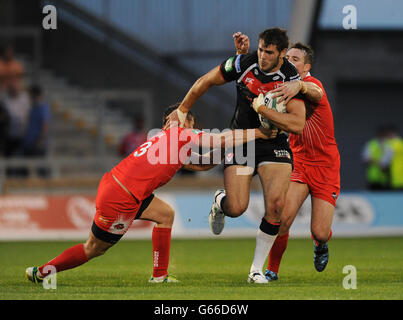 Salford City Reds' Ashley Gibson is tackled by St. Helens' Joe ...