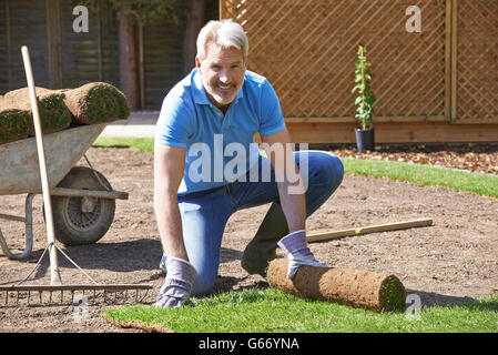 Landscape Gardener Laying Turf For New Lawn Stock Photo - Alamy