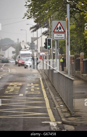 A children crossing patrol sign approaching a pedestrian crossing ...