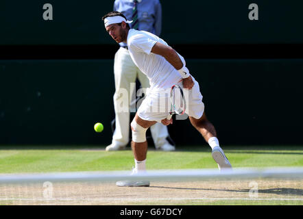 Novak Djokovic plays a shot through his legs during his Gentlemen's ...