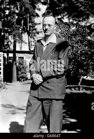 Atom spy Dr Klaus Fuchs wearing glasses, arrives at East Berlin Airport ...