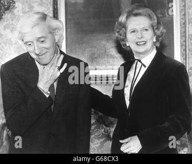 TV and radio star Jimmy Savile enjoys a cigar with fellow smoker and ...