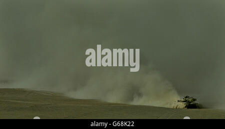 Challenger II battle tanks move through the Kuwaiti desert. Photo by ...