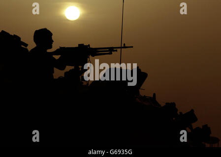 Iraqis move through a British Army checkpoint on the Basra road, Iraq ...