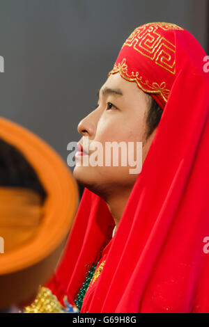 Participants in traditional attire perform rituals with candles during ...