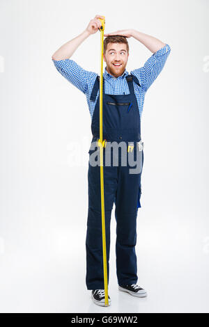 Hand of hispanic man holding funny piggy bank with glasses over ...