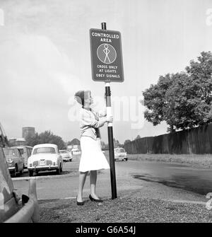 A new type of road sign is installed just this side a pedestrian ...