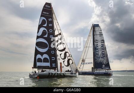 Alex Thomson's Open 60 racing yacht Hugo Boss (right) at the start of ...