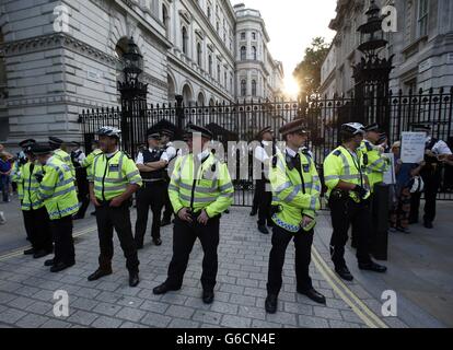 Police stand guard during a protest outside the Iranian Embassy in ...