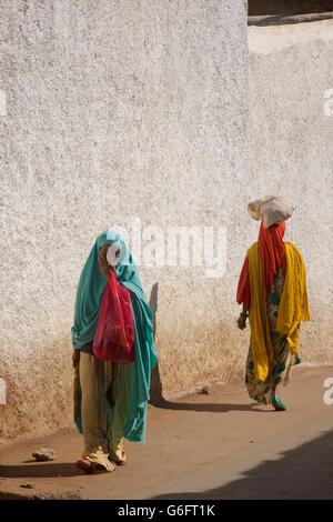 Harari women walking in the street wearing colourful clothing. Harar ...
