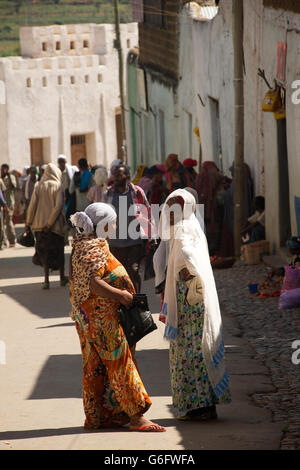 Harari women walking in the street wearing colourful clothing. Harar ...