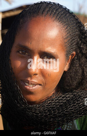 Portrait of an Oromo mother with child with scarification and stylised ...