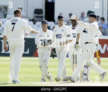 Lancashire bowler Carl Hooper (left) celebrates with Ian Sutcliffe ...