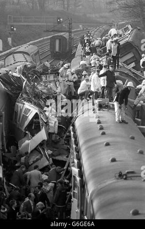 Rescue workers clamber over the wreckage of three trains that crashed ...