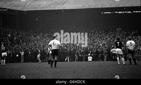 West Ham players watch on as referee Tony Harrington goes over to var ...